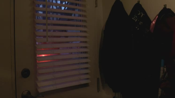 Video: Police lights flashing outside the window of a home at dusk The ...